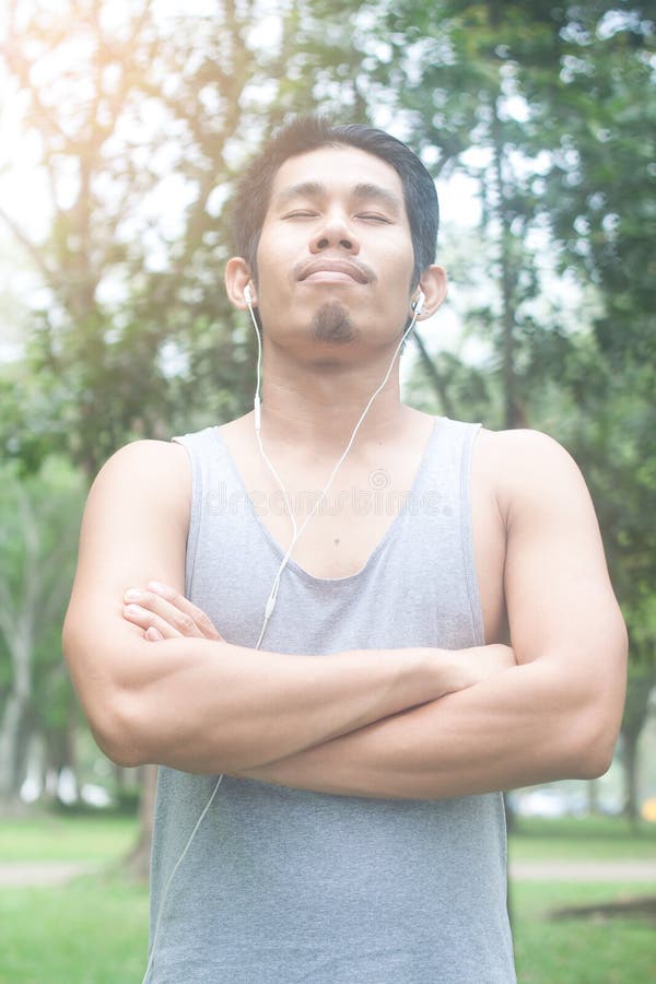 Man Relaxing while Listening Music Stock Photo - Image of music, green ...
