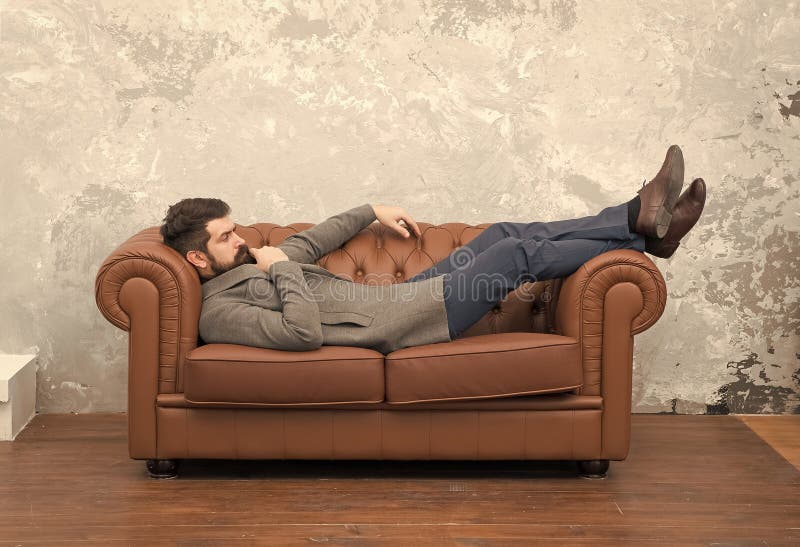Man Relaxing on Luxurious Leather Couch, Thoughtful Mood Concept Stock ...