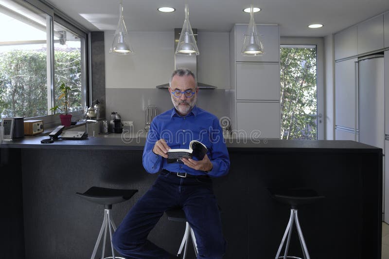 Man Relaxing and Reading on a Kitchen Stock Image - Image of elderly ...
