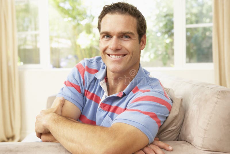 Man Relaxing on Sofa at Home Stock Image - Image of caucasian, sofa ...