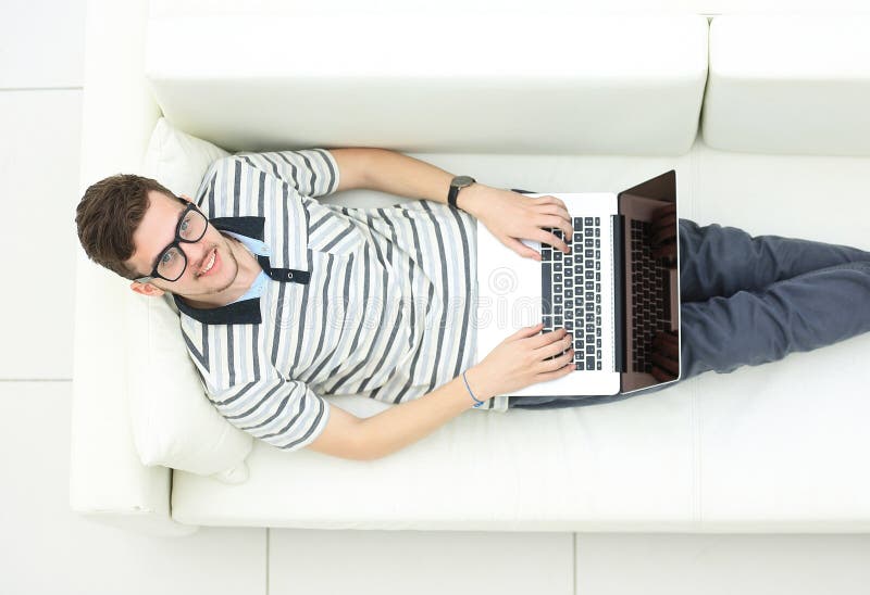 Man Relaxing on Sofa with Laptop Computer Stock Photo - Image of couch ...