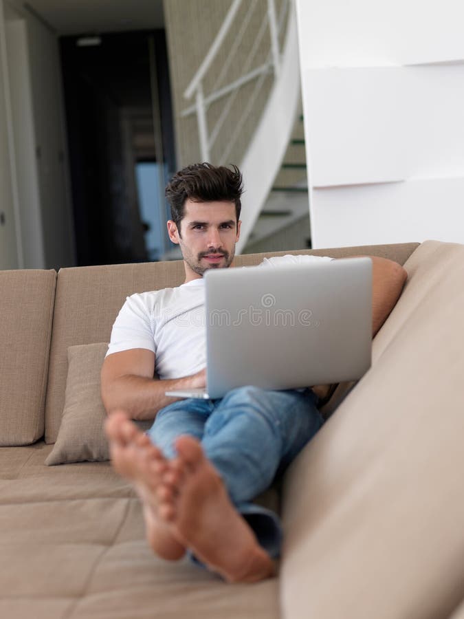 Man Relaxing on Sofa and Work on Laptop Computer Stock Photo - Image of ...