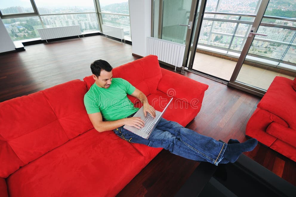Man Relaxing on Sofa and Work on Laptop Computer Stock Photo - Image of ...