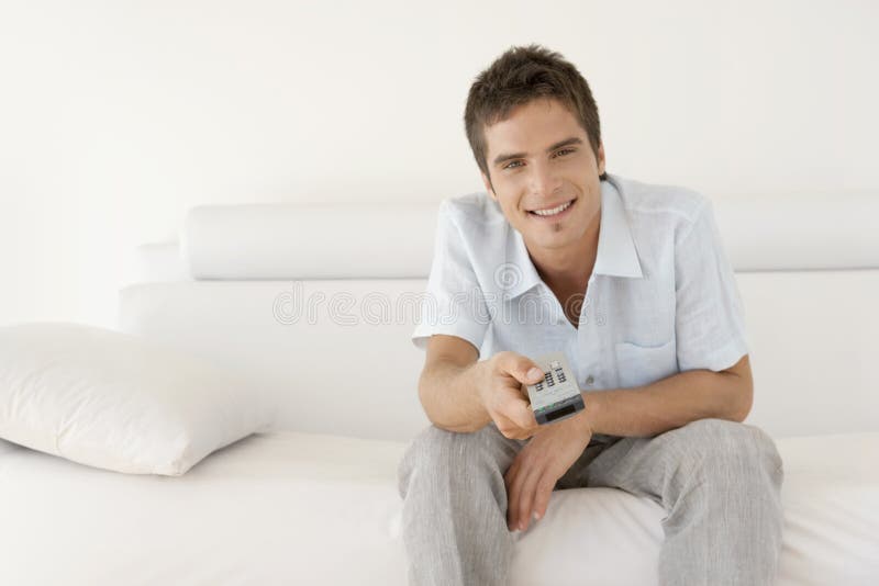 Man Relaxing Using Remote Control Stock Image - Image of expensive ...