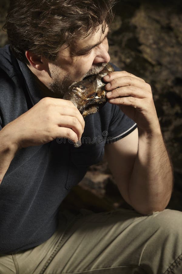 Man Relaxing in Wilderness and Eating Hunted Fish Stock Photo - Image ...