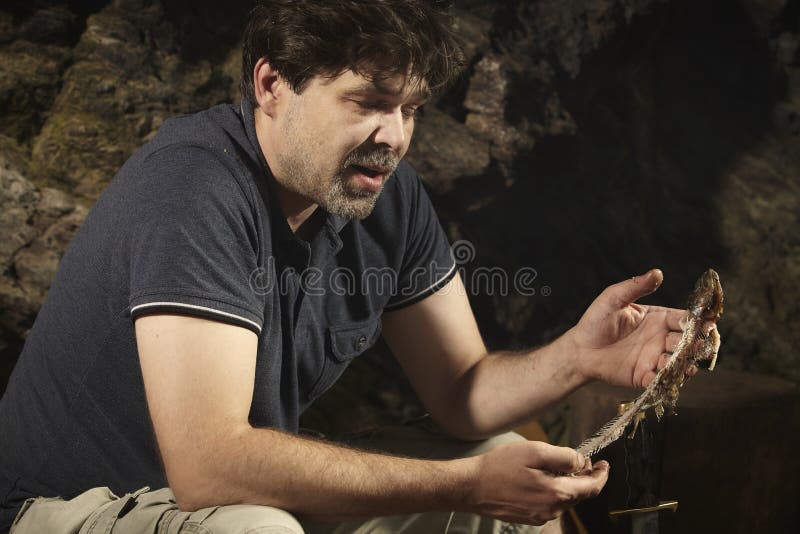 Man Relaxing in Wilderness and Eating Hunted Fish Stock Image - Image ...