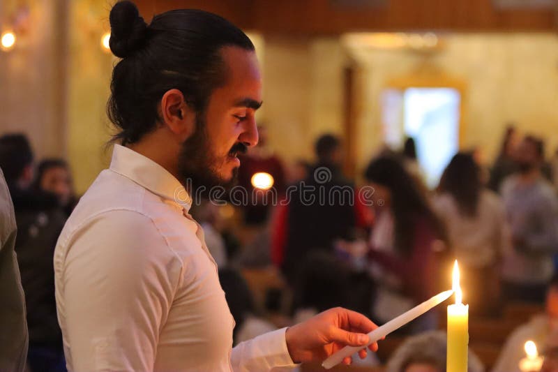Man in a Religious Setting Participating in a Ceremony by Lighting a ...