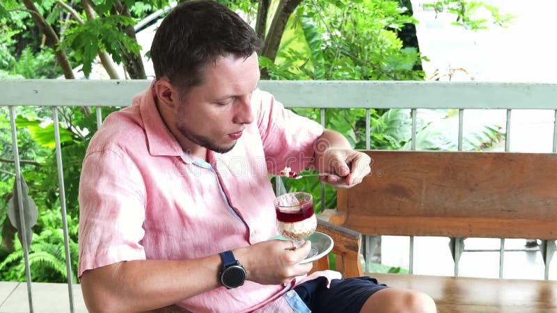 A Man is Relishing a Delightful Meal and Drinks in a Modern Cafe Stock ...