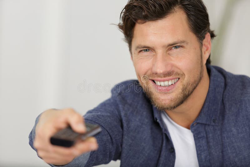Man with remote control stock image. Image of midadult - 200001475