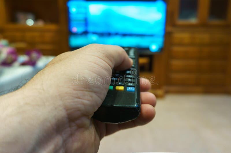Man with a Remote Control Changing the TV Program. Stock Photo - Image ...