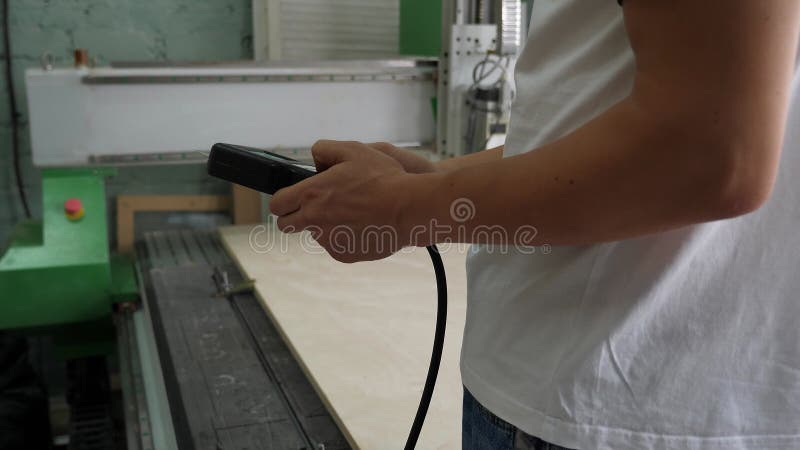 A Man with a Remote Control Turns on a Program on a Modern Laser on ...