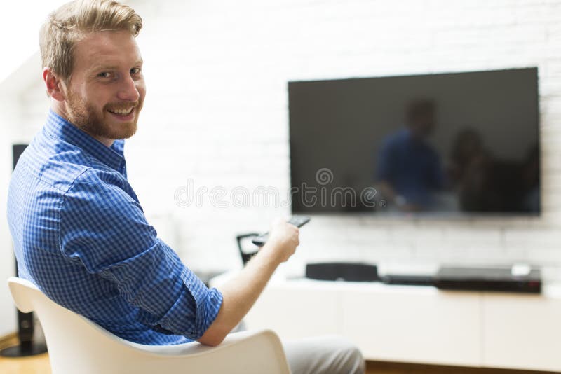 Man with remote control stock image. Image of television - 78998841