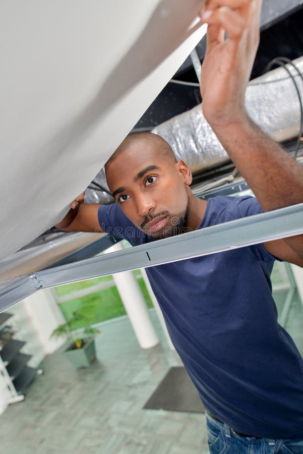 Man Removing Ceiling Panels Stock Image - Image of equipment ...