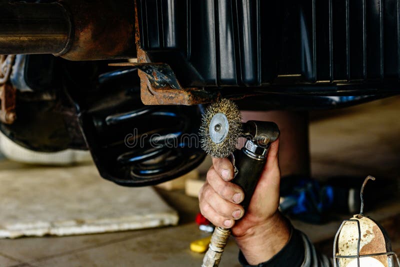 Man Removing Rust from Car Parts. Car Body Corrosion. Stock Photo ...