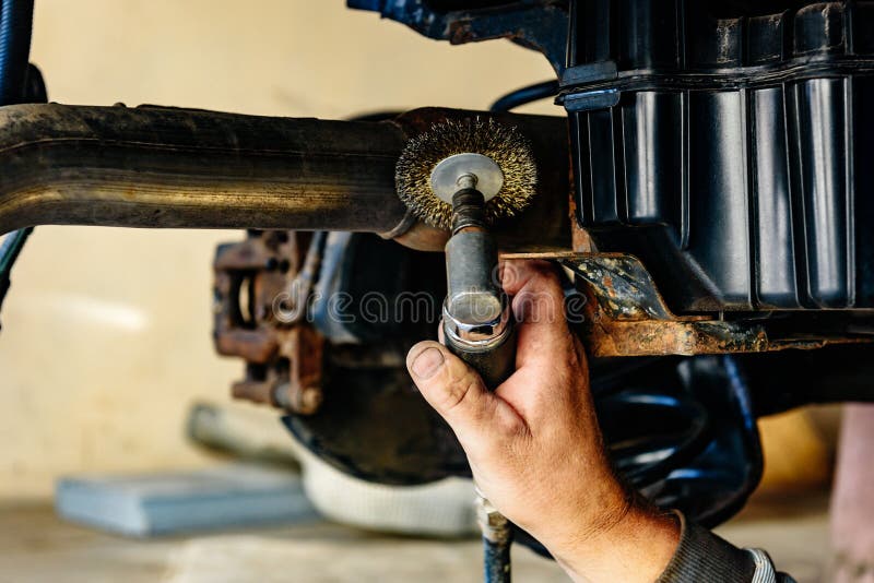 Man Removing Rust from Car Parts. Car Body Corrosion. Stock Photo ...