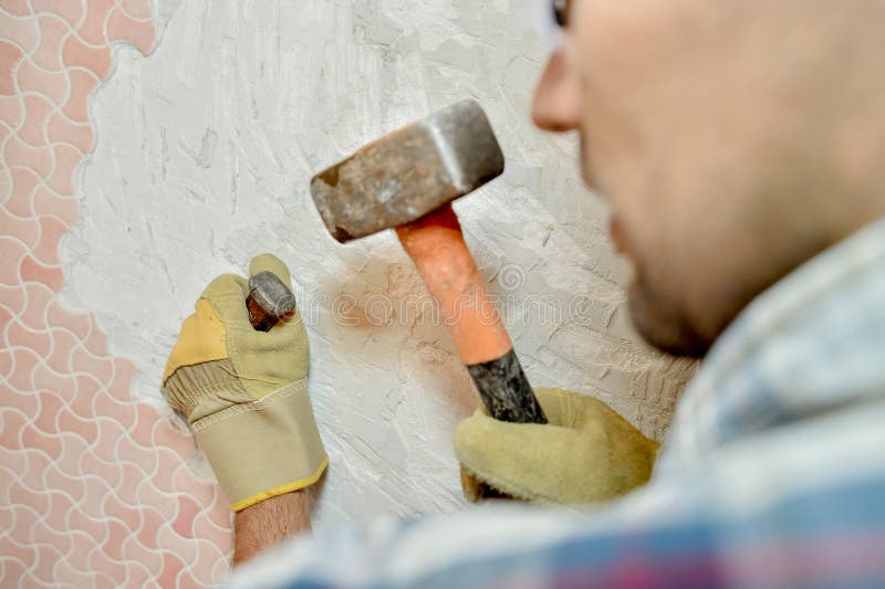 Man Removing Tiles from Wall with Hammer and Chisel Stock Photo - Image ...