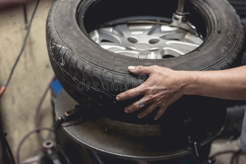 A Man Removing a Tire from the Rim after Using a Tire Bead Breaker at a ...
