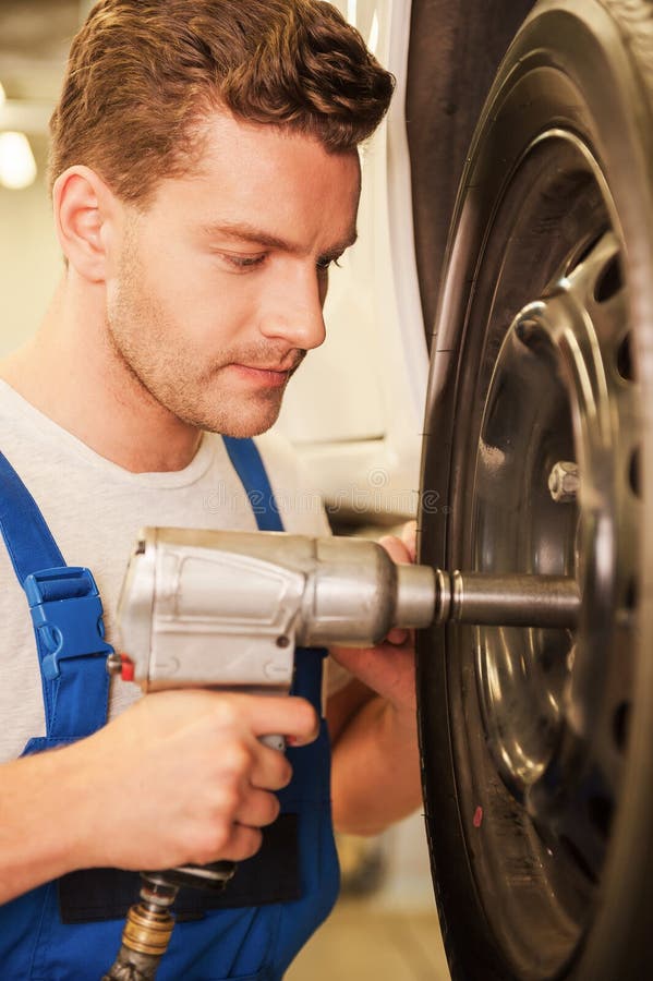 Man removing tires. stock image. Image of land, occupation - 54839573