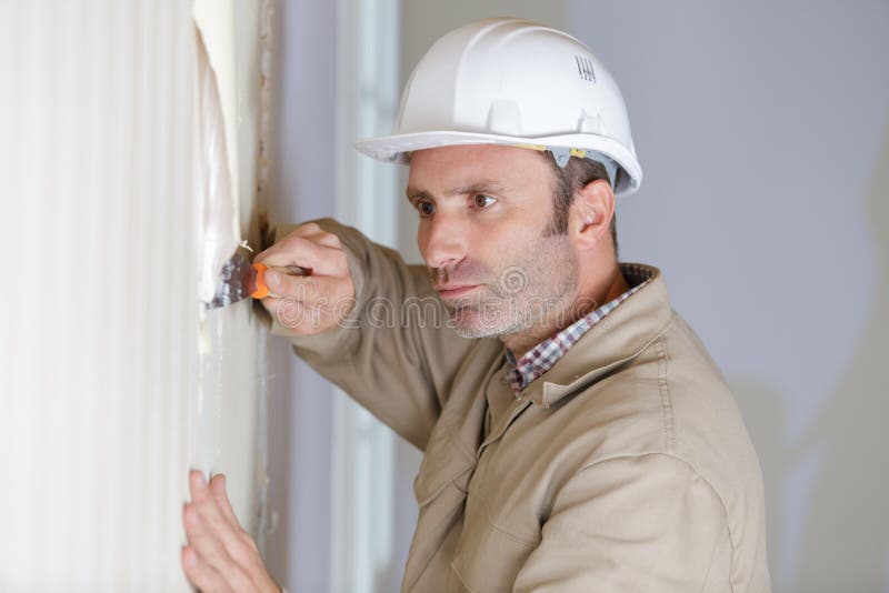 Man removing wallpaper stock image. Image of renovation - 238086593