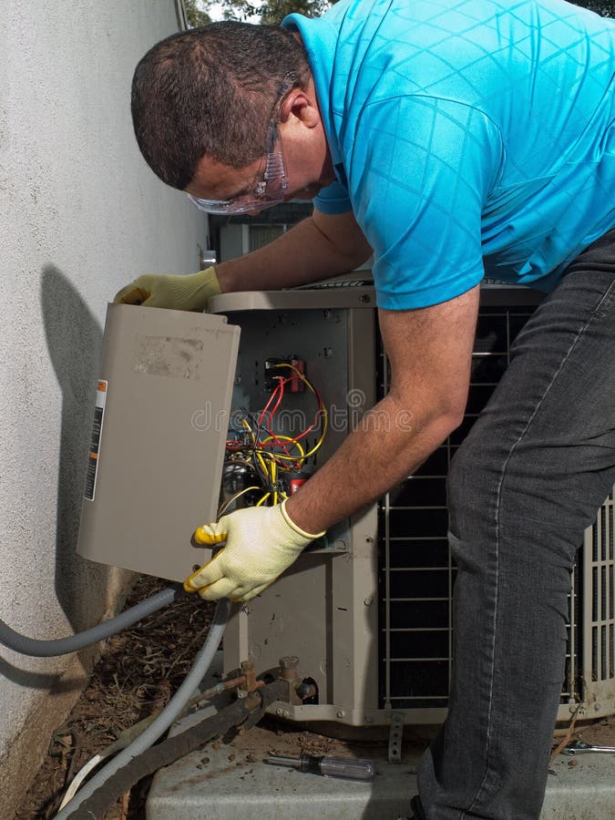 Man fixing air conditioner stock photo. Image of hands - 28623748