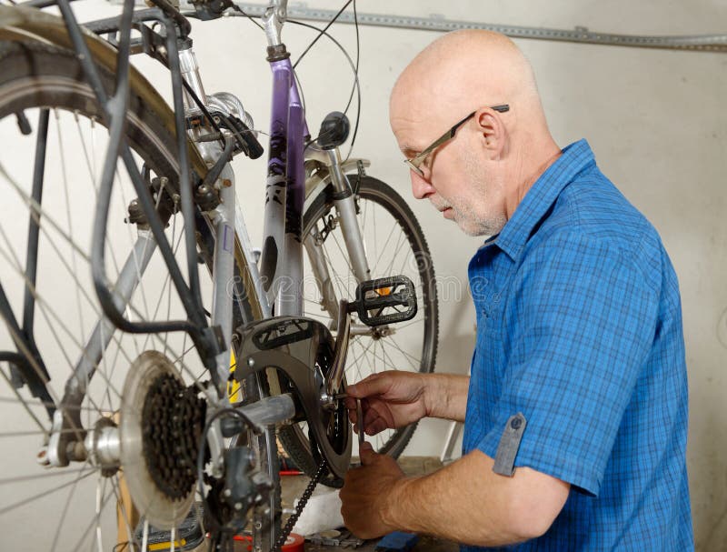Man Repairing Bicycle in His Workshop. Stock Photo - Image of cycle ...