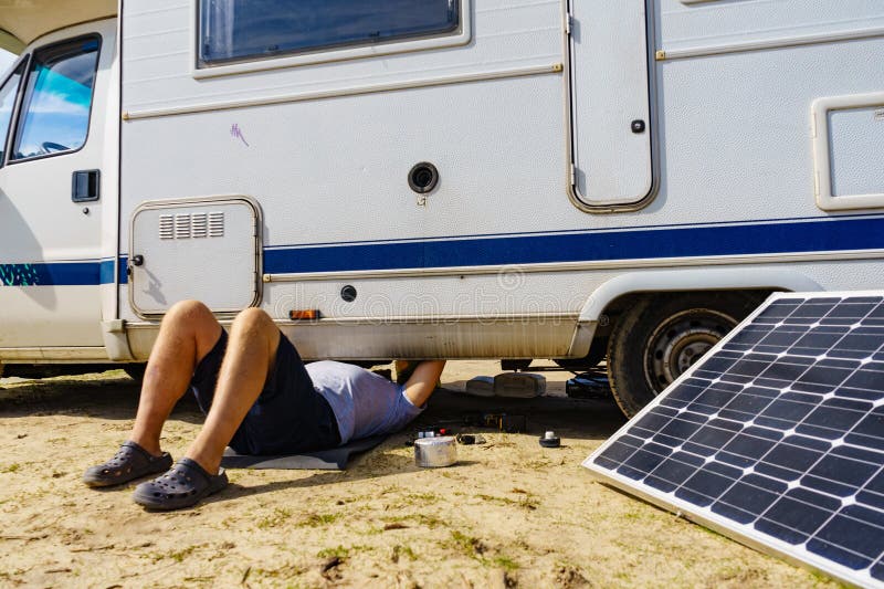 Man Repairing Bottom of the Rv Caravan Stock Photo - Image of montage ...