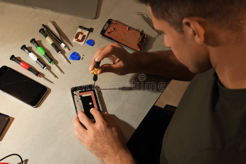 Man Repairing Broken Smartphone at Table, Above View Stock Image ...