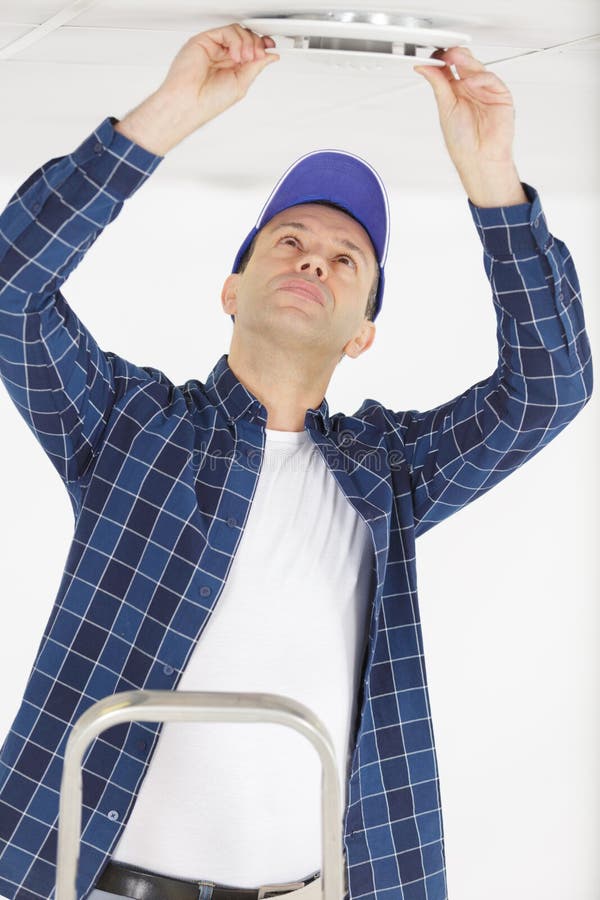 Man repairing ceiling stock image. Image of working - 263005553