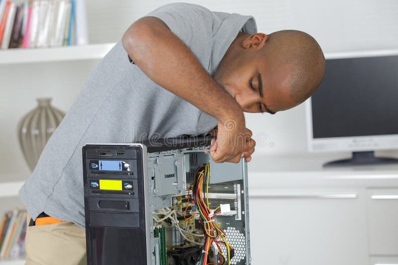 Man Repairing Computer while Sitting at Working Place Stock Photo ...