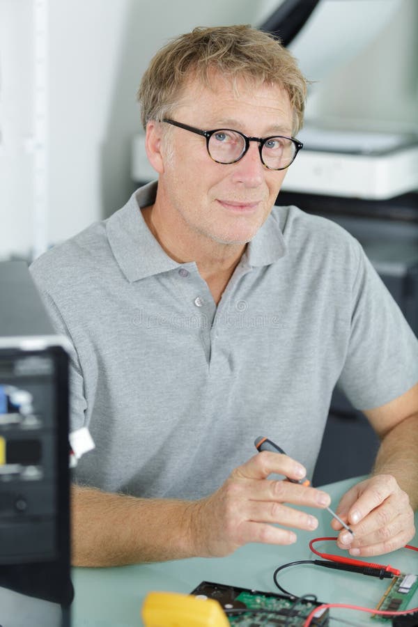 Man Repairing Computer Using Multimeter Stock Photo - Image of ...