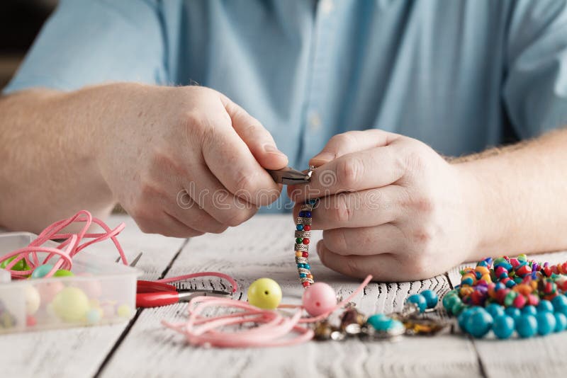 Man Repairing or Creating Jewelry Silver Chain with Pliers Stock Image ...