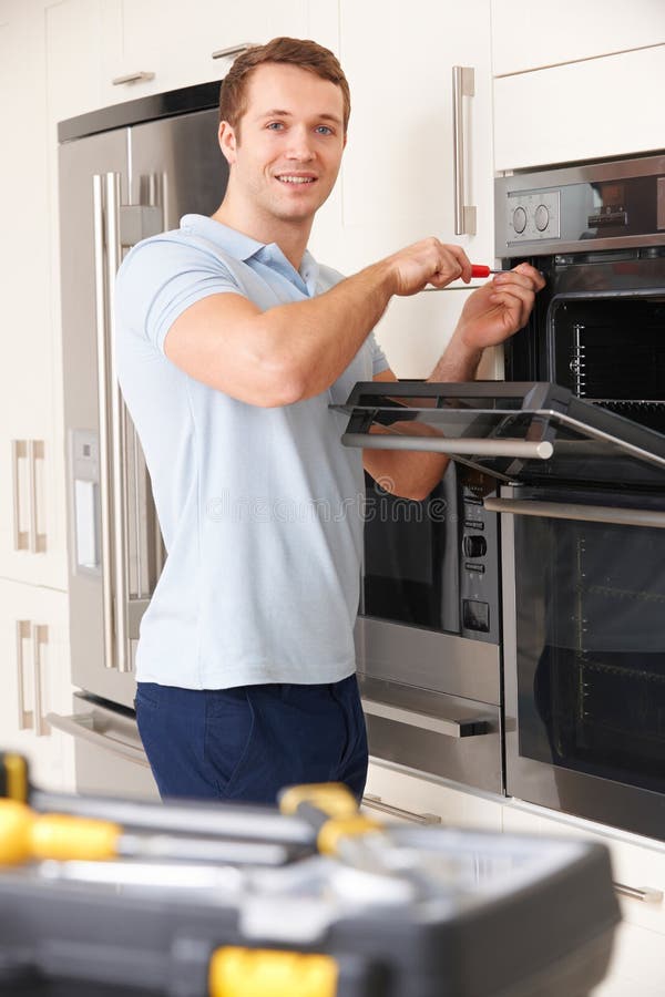 Man Repairing Domestic Oven in Kitchen Stock Image - Image of ...
