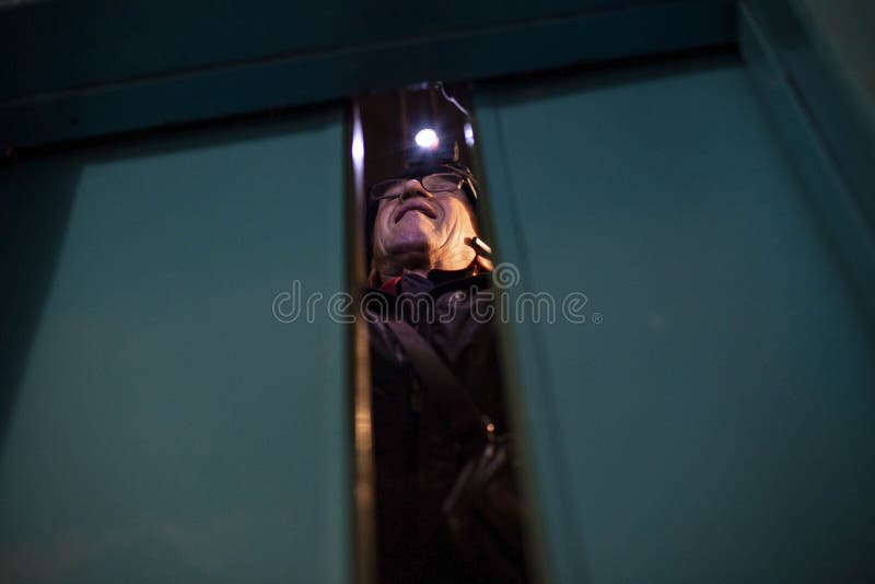 Man Repairing an Elevator at Night Inside a Shaft of a High-rise ...