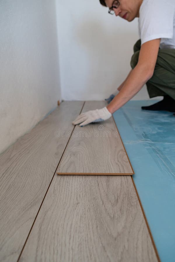 Man is Repairing the Floor in the House, Laminate Flooring. Stock Photo ...