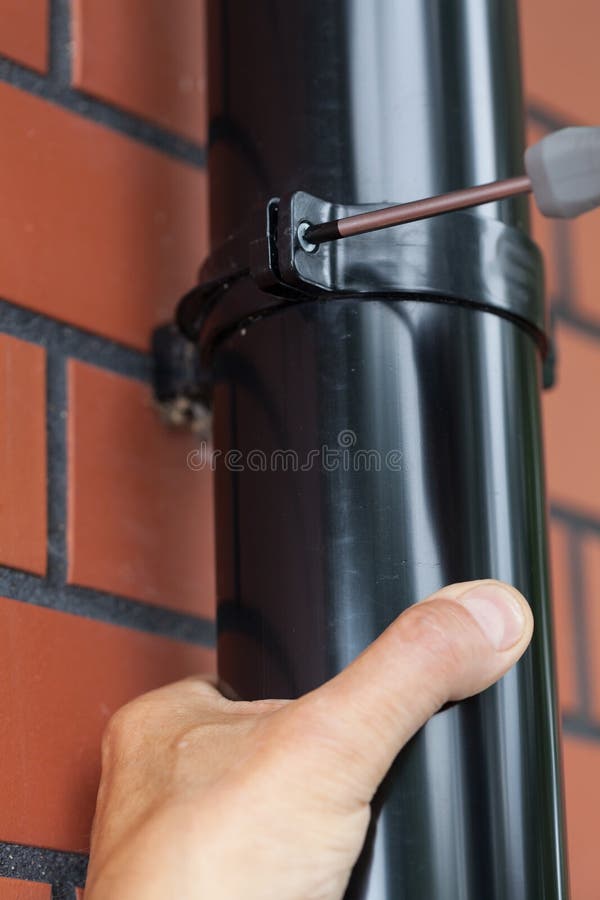Man is repairing a gutter stock photo. Image of installing - 44138854