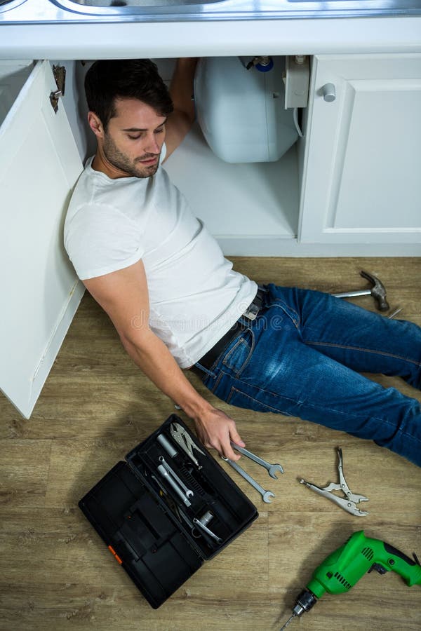 Man Repairing a Kitchen Sink Stock Image - Image of kitchen, electrical ...