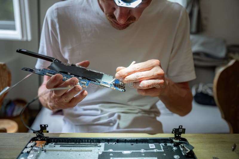 Man Repairing Laptop with Tools on Table, Computer Maintenance Concept ...