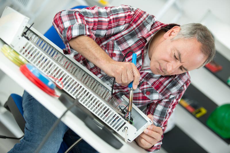 Man Repairing Radiator with Soldering Iron Stock Photo - Image of ...