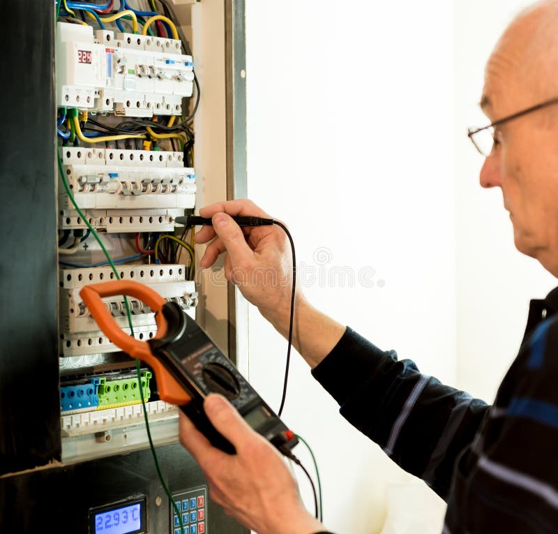 The Man is Repairing the Switchboard Voltage with Automatic Switches ...