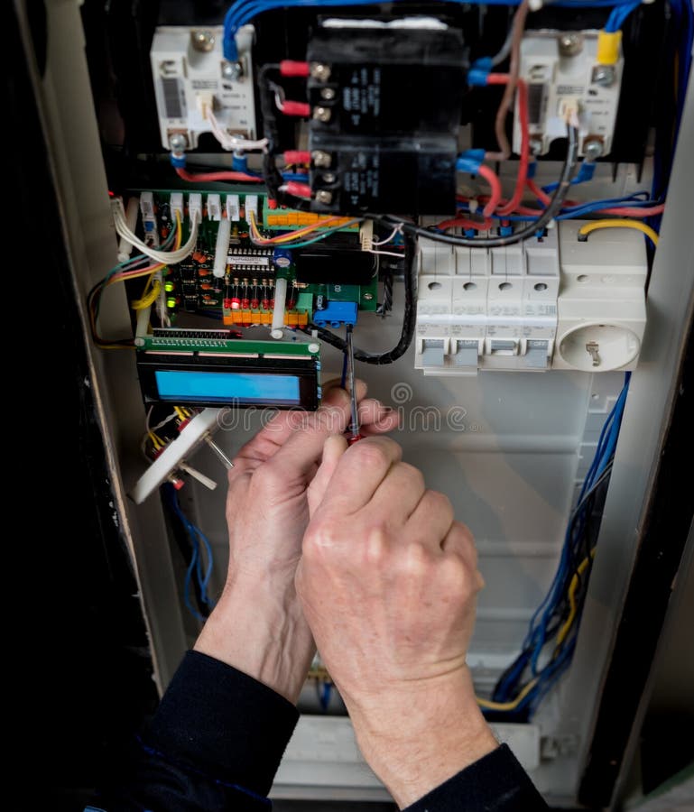 The Man is Repairing the Switchboard Voltage with Automatic Switches ...