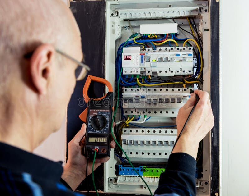 The Man is Repairing the Switchboard Voltage with Automatic Switches ...