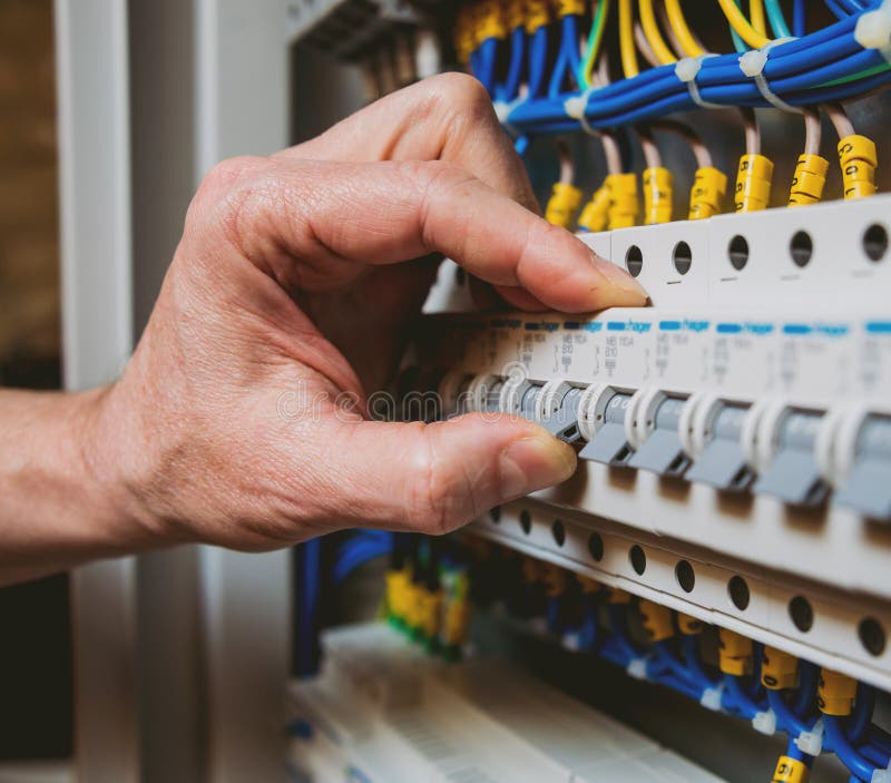 The Man is Repairing the Switchboard Voltage with Automatic Switches ...