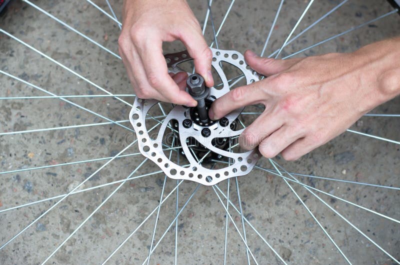 A Man Repairs a Bicycle Wheel Stock Image - Image of cyclist, closeup ...