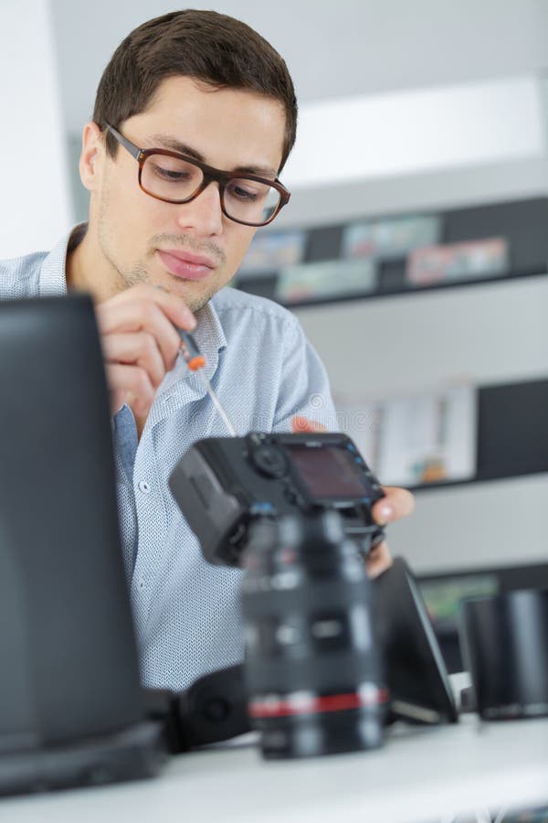 Man Repairs Camera in Workshop Stock Image - Image of motherboard ...