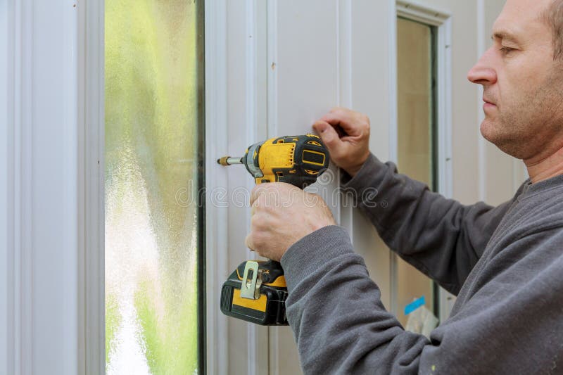 Man Repairs Window Frame Using Power Drill in Home Renovation Project ...