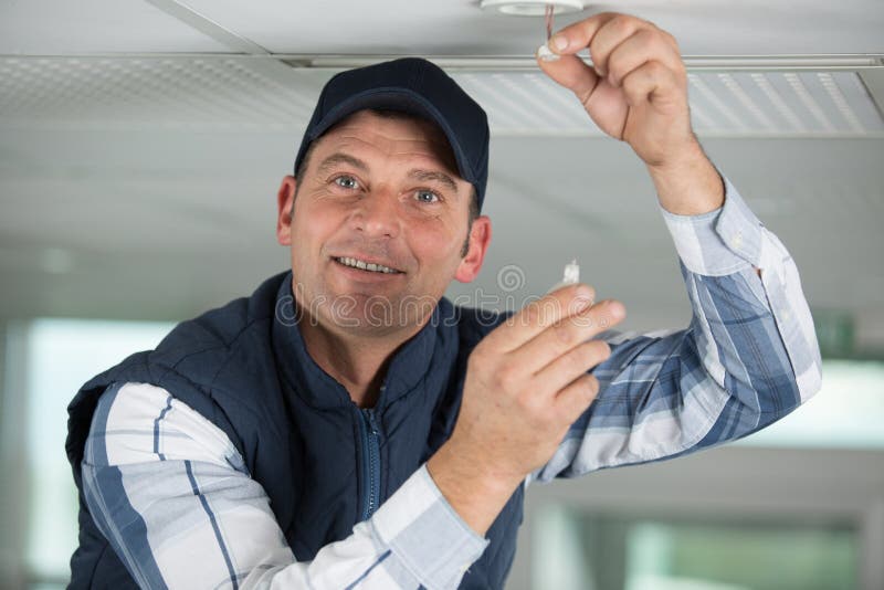 Man Replacing Ceiling Light Bulb Stock Photo - Image of fixing ...