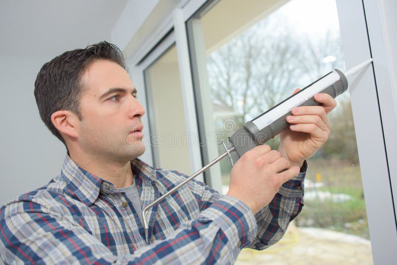Man Replacing Silicone Windows Stock Photo - Image of labor, builder ...