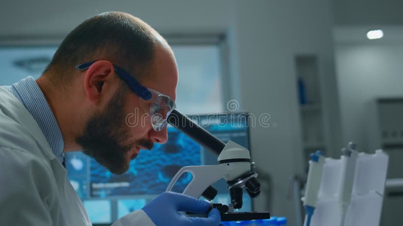 Man Research Scientist Looking at Samples Under Microscope Stock ...