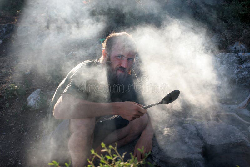 The Man at Rest with a Large Spoon at the Fire Stock Image - Image of ...