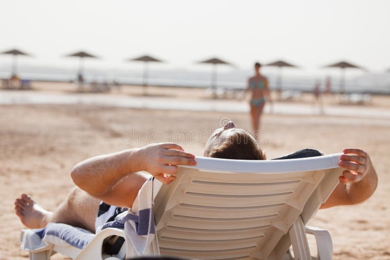 Man resting in beach chair stock photo. Image of relax - 13191332